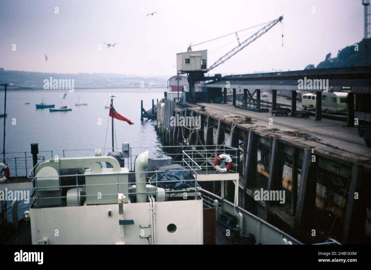 View of port quayside with crane from ship in the harbour at Fishguard ...