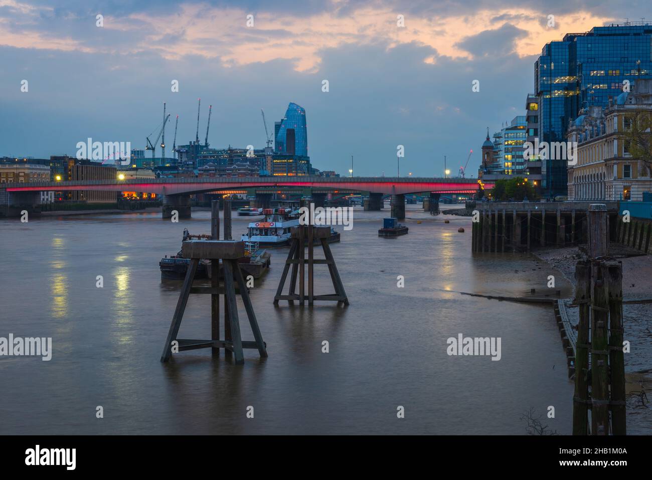 Night time view along River Thames from Sugar quay Wharf with London ...
