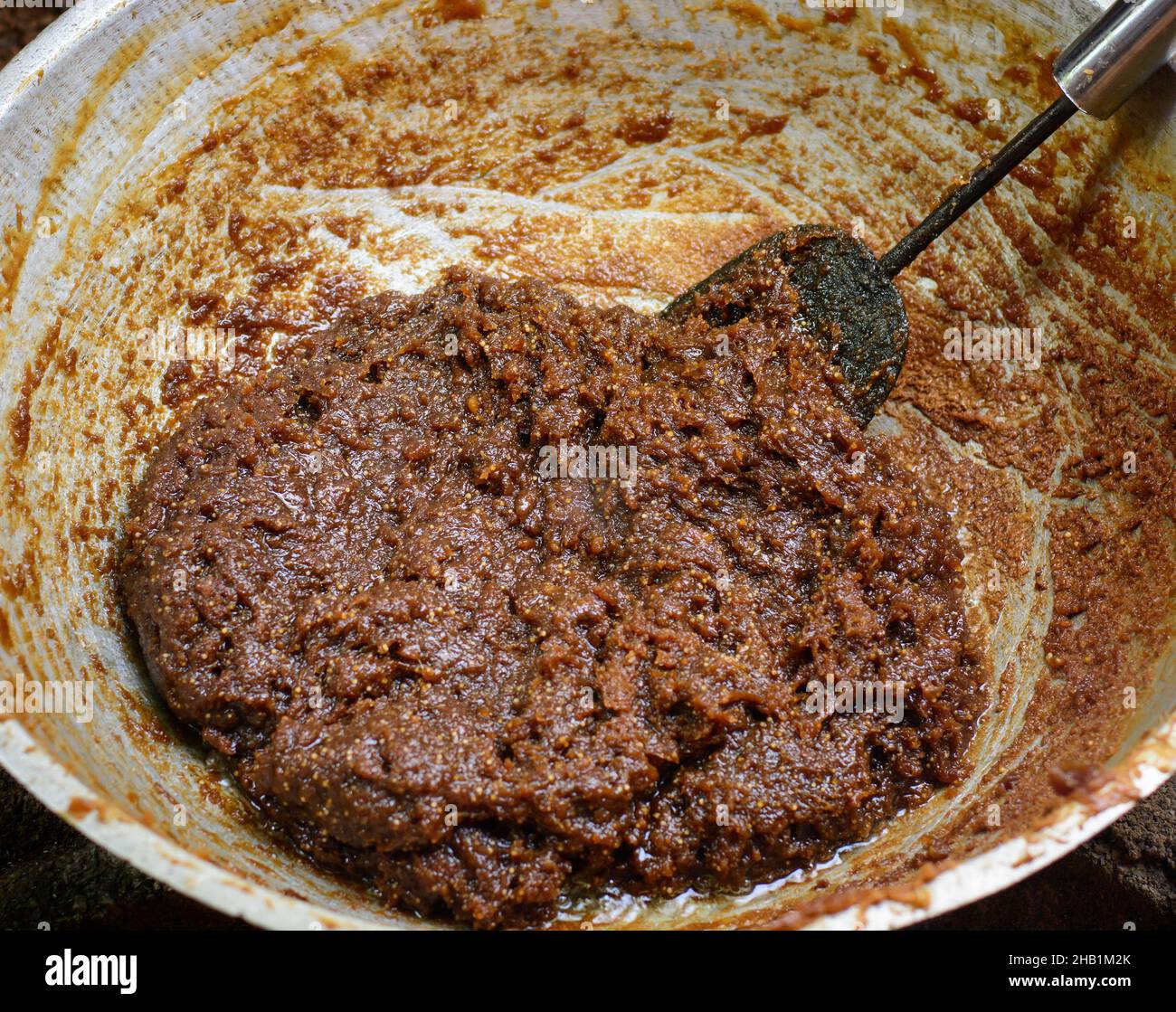 making dodol in a large container, also called kalu dodol in sri lanka ...