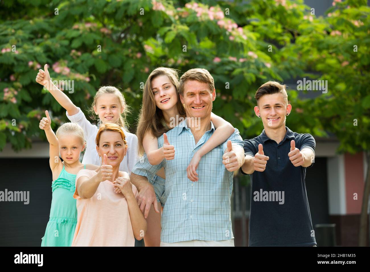 the large family with thumbs up outdoor Stock Photo - Alamy