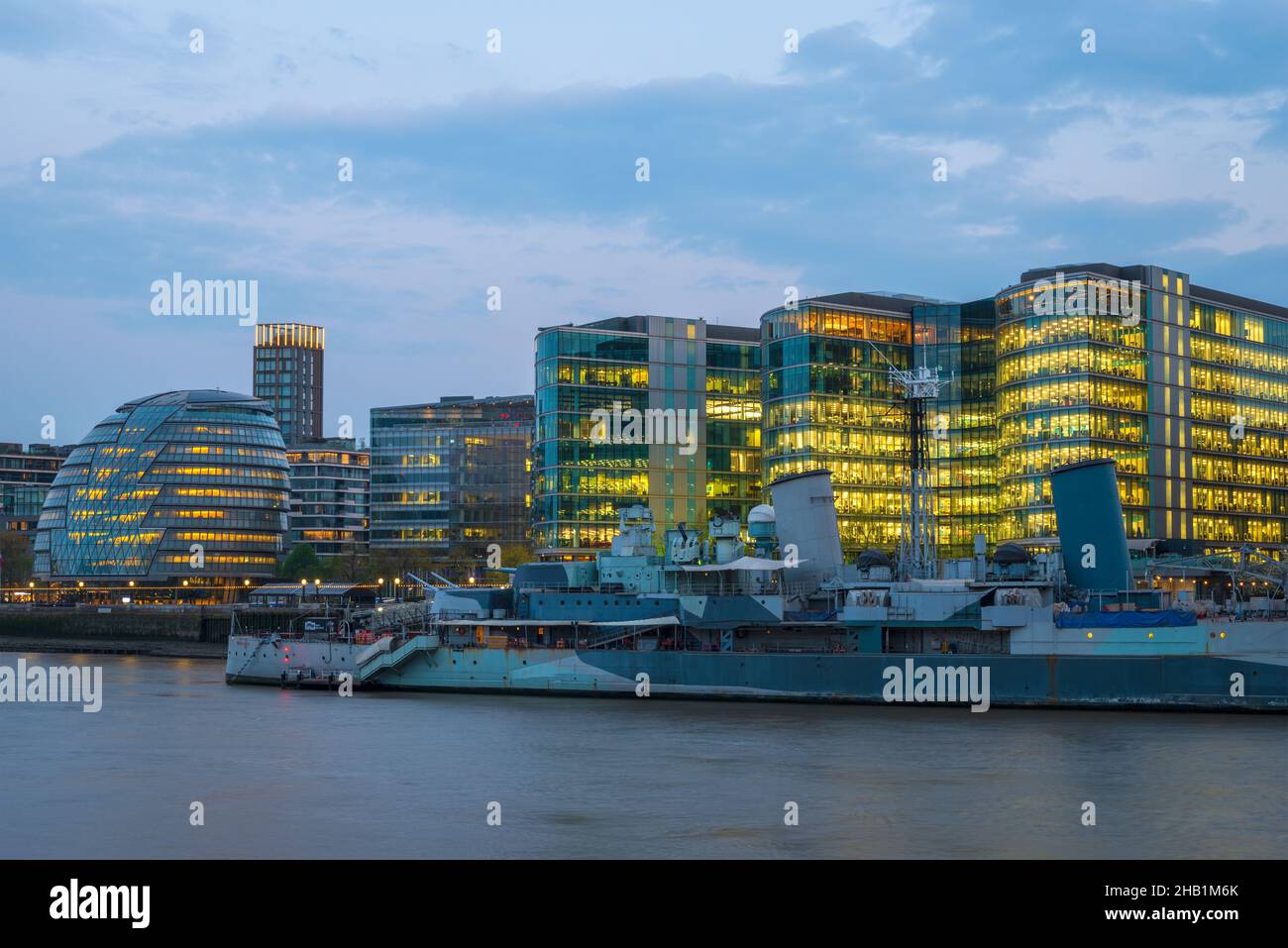 A night time view across the River Thames, from Sugar Quay, of HMS ...