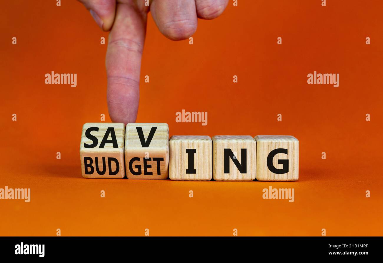 Budgeting and saving symbol. Businessman turns wooden cubes and changes ...