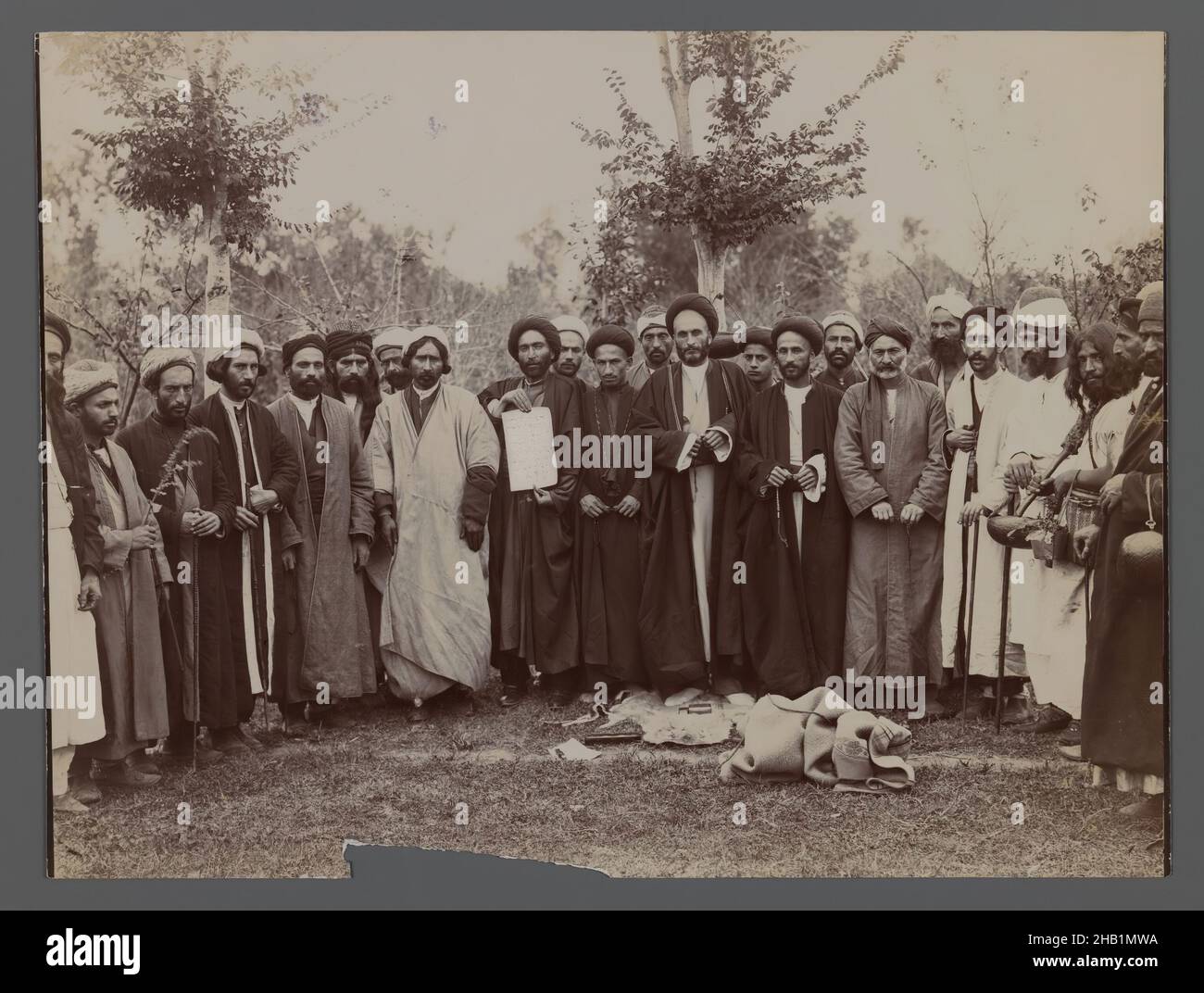 A Group of Religious Men in Religious Garb holding up a Piece of ...