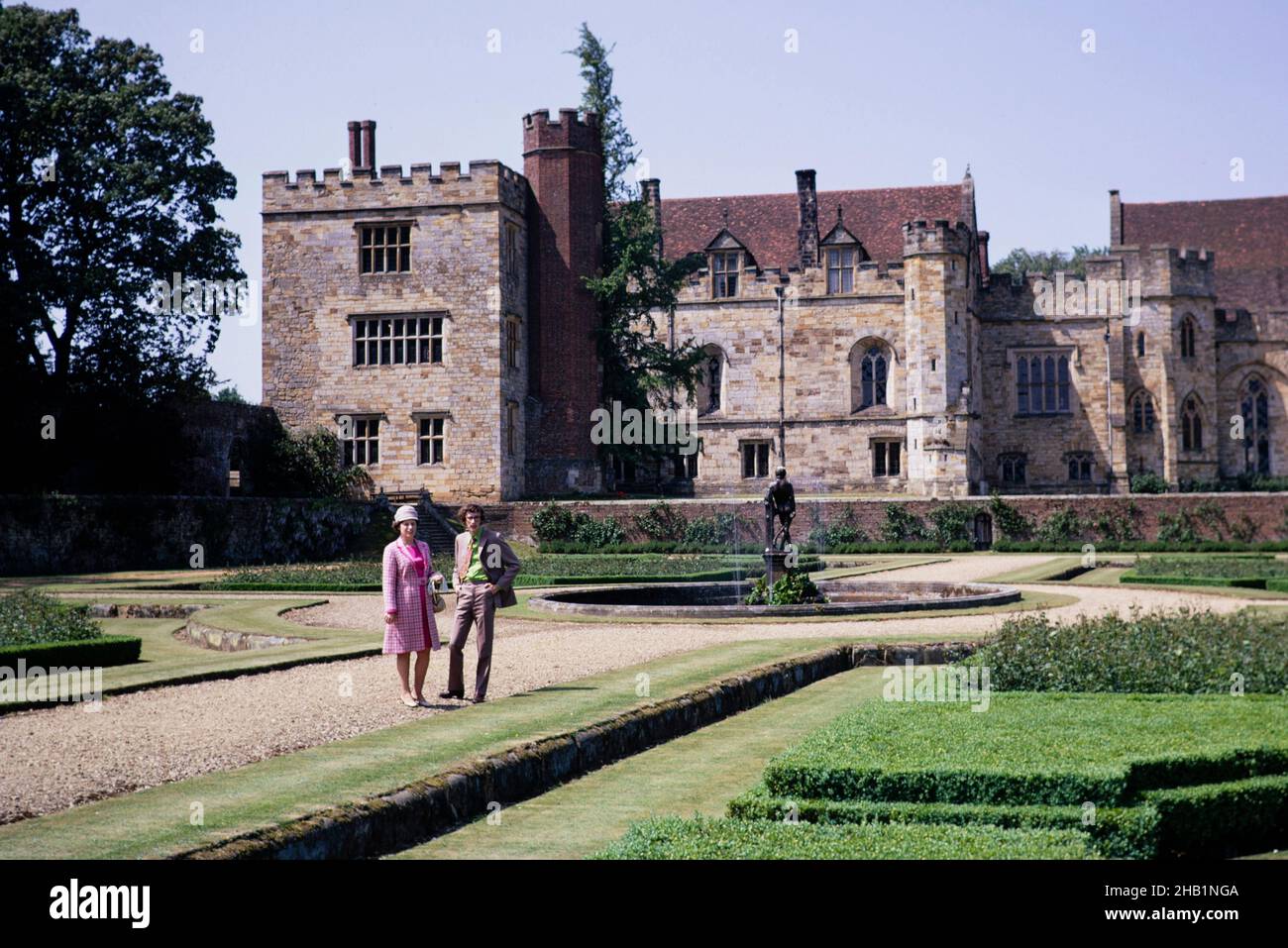 Man and woman standing in gardens of Penshurst Place and castle, Kent ...