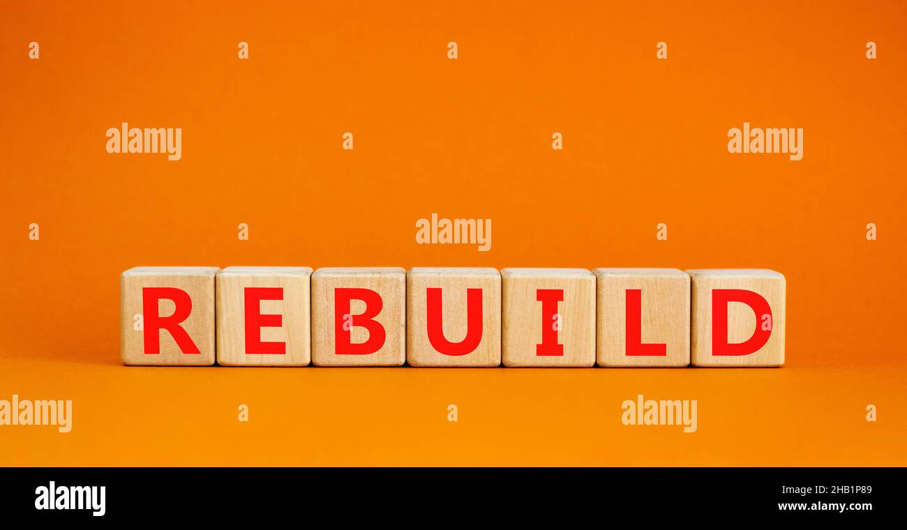Rebuild and build symbol. The concept word Rebuild on wooden cubes ...
