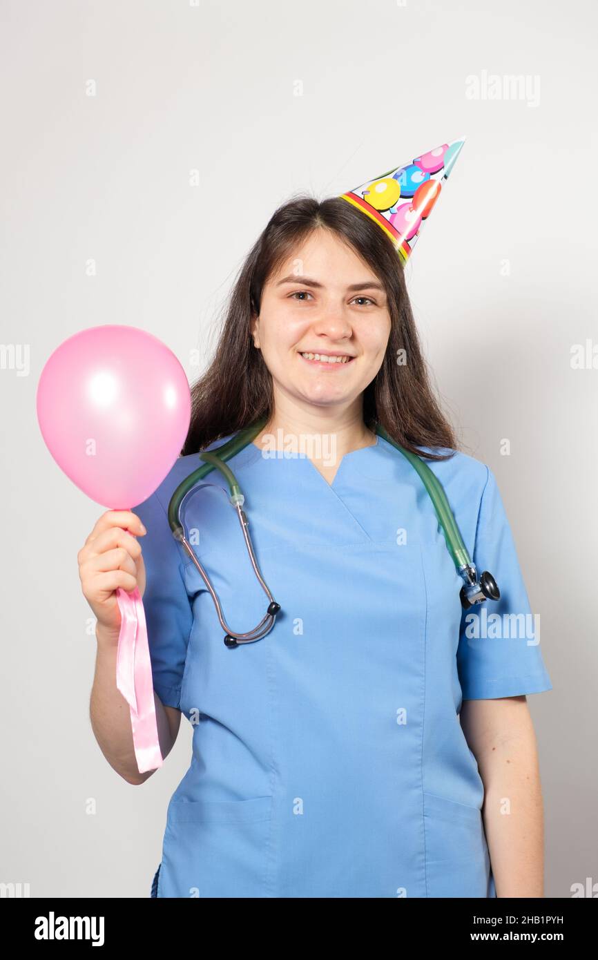 The doctor holds a festive balloon and smiles, happy doctor's day Stock ...
