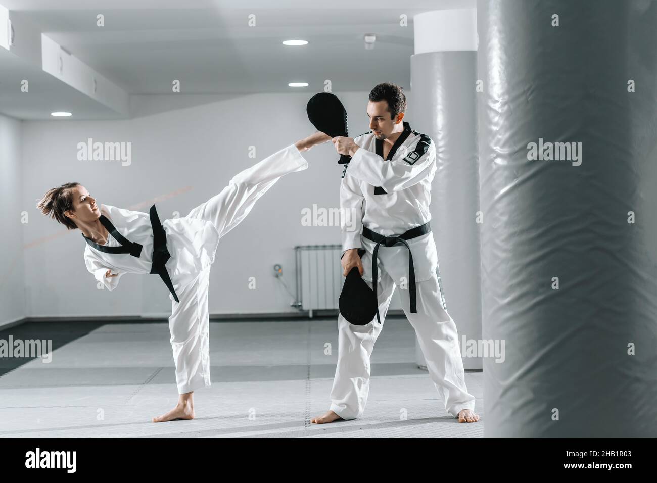 Caucasian handicapped highly motivated girl practicing taekwondo with ...