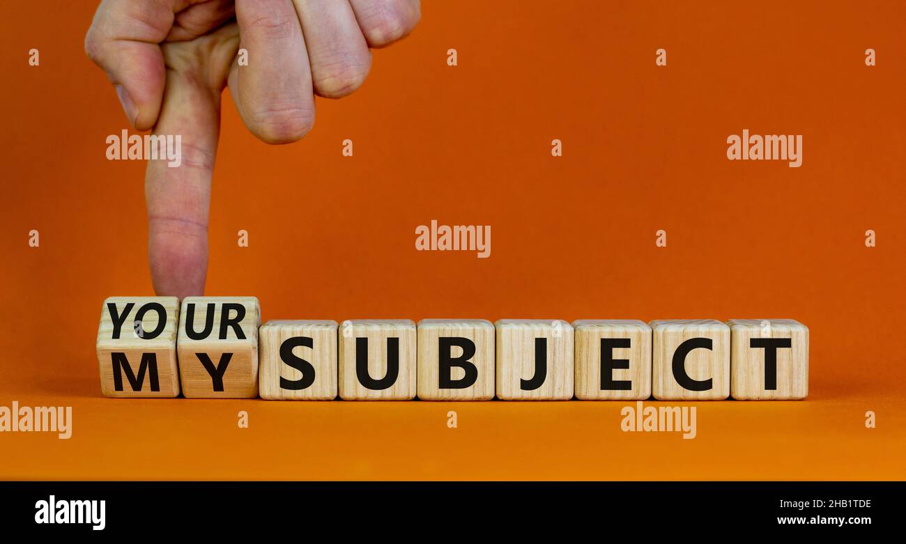 My or your subject symbol. Businessman turns wooden cubes and changes ...