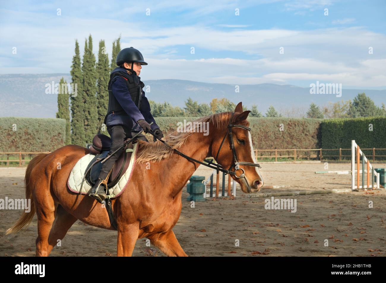 Kid riding horse at the ranch with obstacles and barriers Stock Photo ...