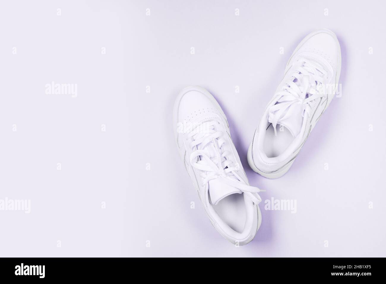 White cream sneakers on isolated pastel background, casual shoes ...