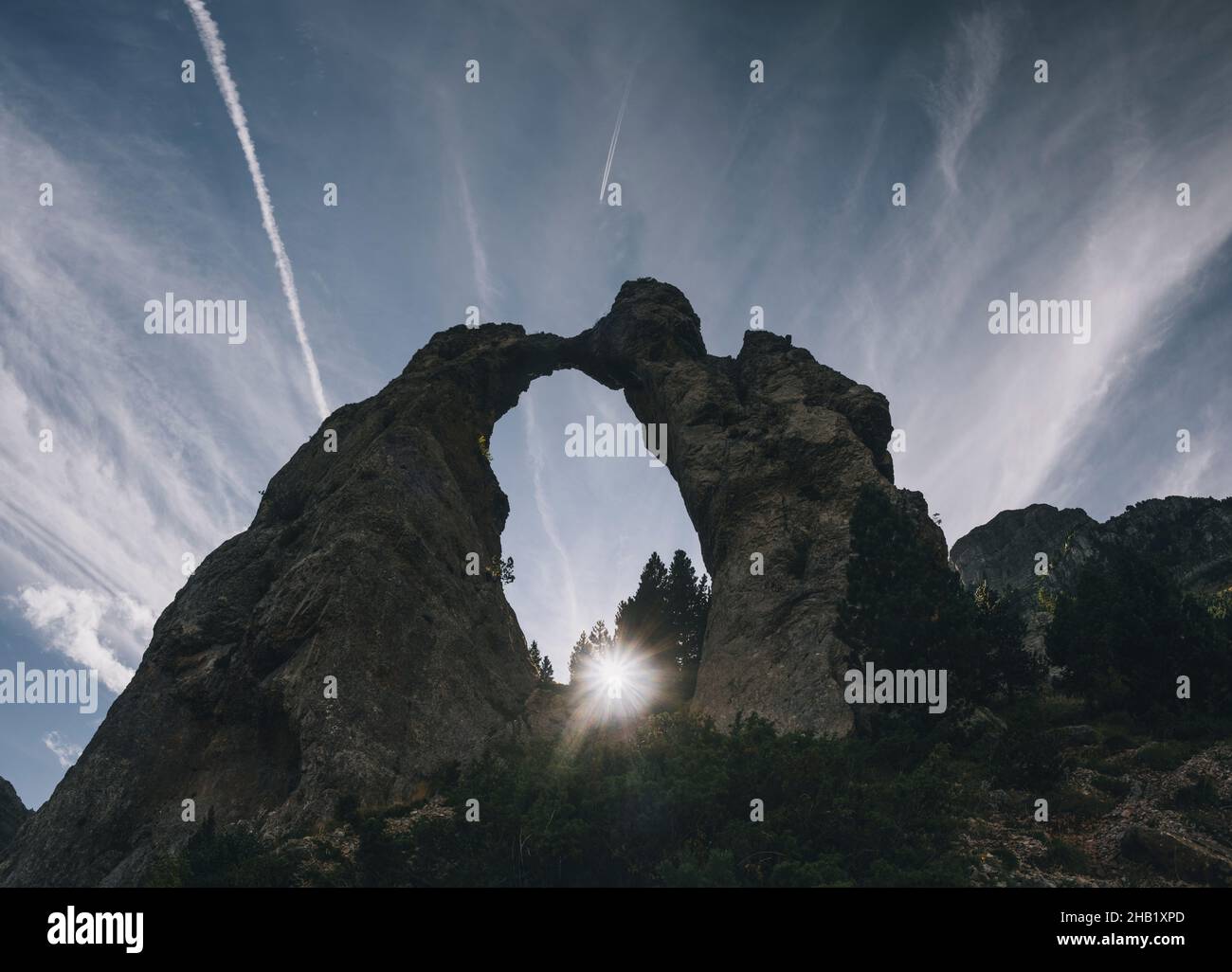 Sun-star in the middle of a rock arch mountain formation, Pyrenees ...