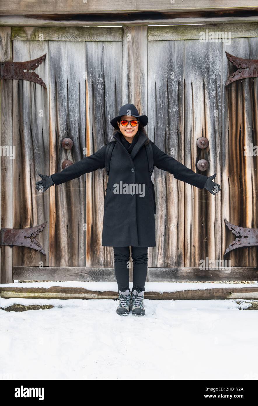 beautiful woman standing in front of a closed wooden gate Stock Photo ...