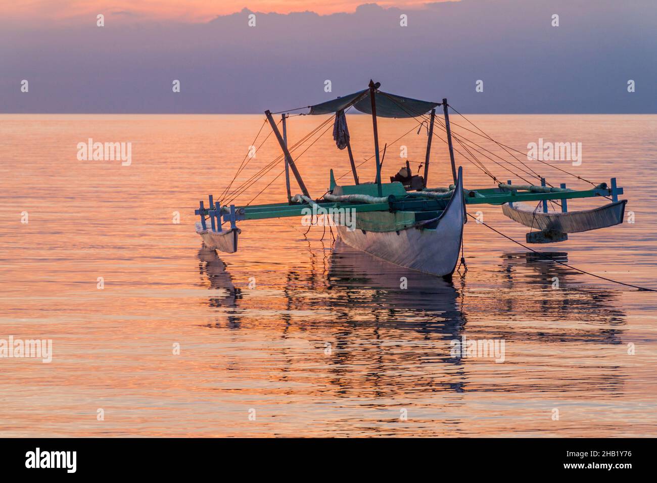 Sunset view of a bangka double-outrigger boat on Siquijor island ...
