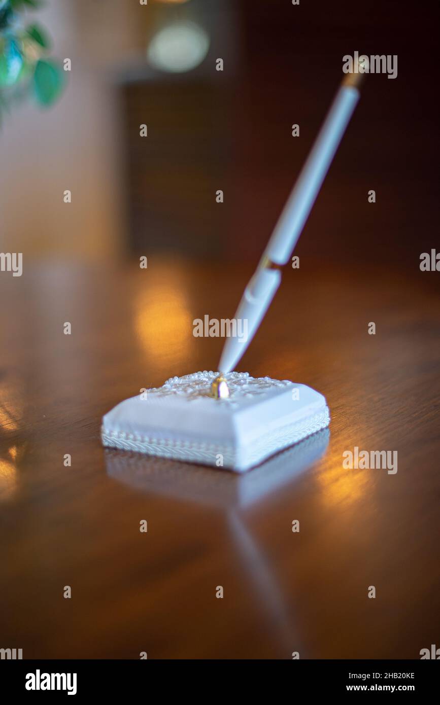 White signing pen in white pen stand on shiny wood table Stock Photo ...