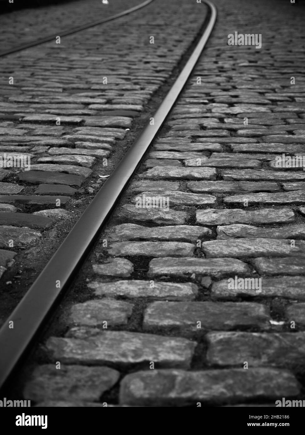 Vertical grayscale shot of a railroad Stock Photo - Alamy