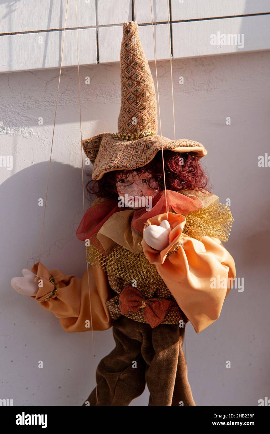 Greek traditional puppet hanging against a white wall of a house in ...