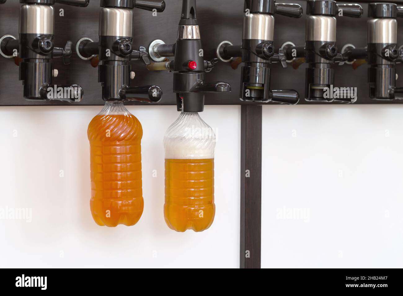 New modern beer taps with plastic bottles on bar counter in pub Stock ...