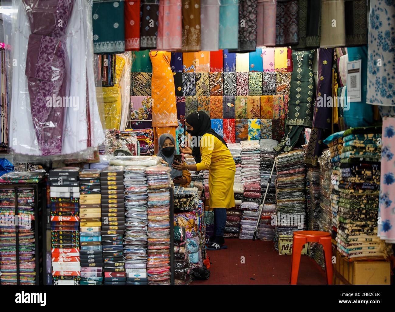 Retail store workers wearing face masks as a precaution against the ...