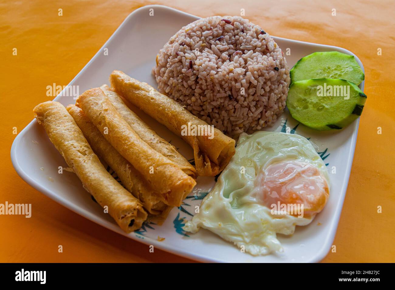 Breakfast in Philippines - rice with fried rolls (lumpia) and egg Stock ...