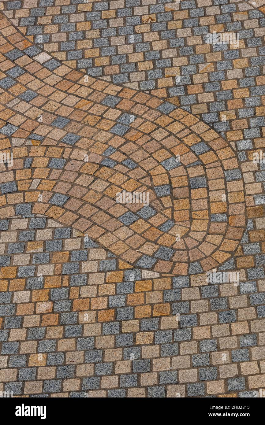 block paving forming an asymmetrical pattern with terracotta umber and ...
