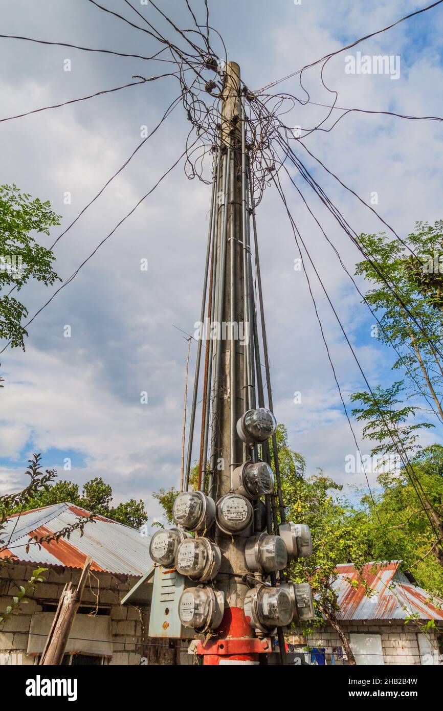 Electricity meter on a pole in Santa Juliana village, Luzon island ...