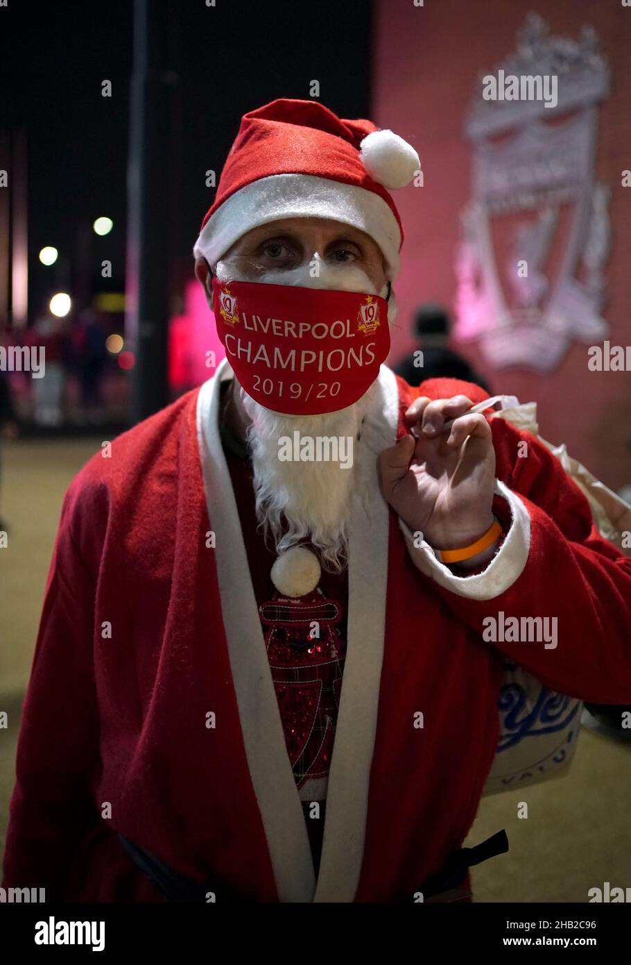 A Liverpool fan dressed as Santa Claus and wearing a face mask that ...