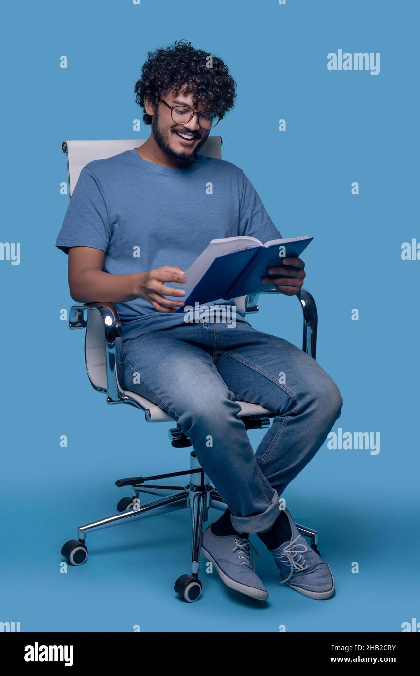 Indian man reading book on hi-res stock photography and images - Alamy