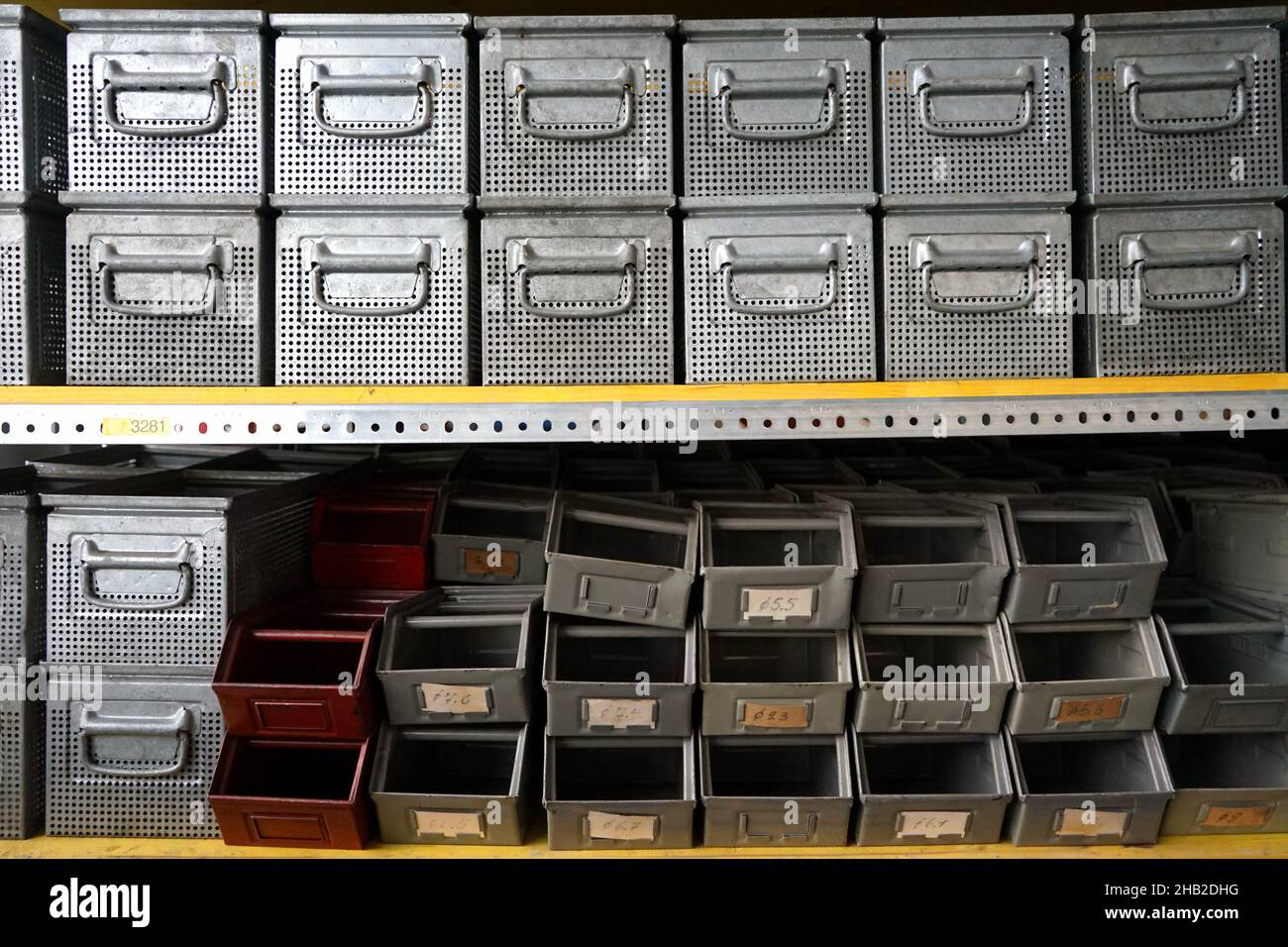Shelf with many silver boxes Stock Photo - Alamy