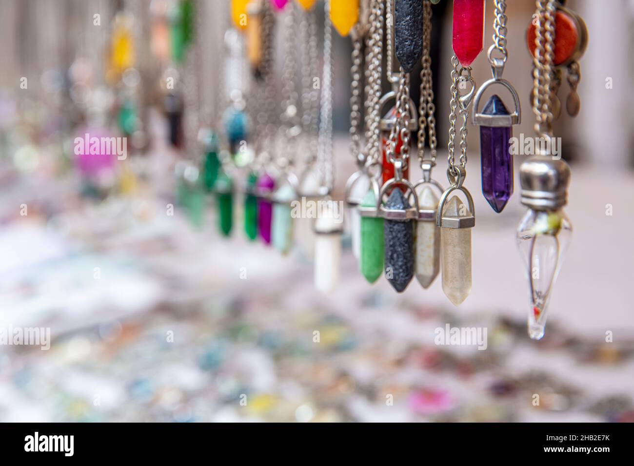 Handmade jewelry on the counter of a street vendor. Necklaces at street ...