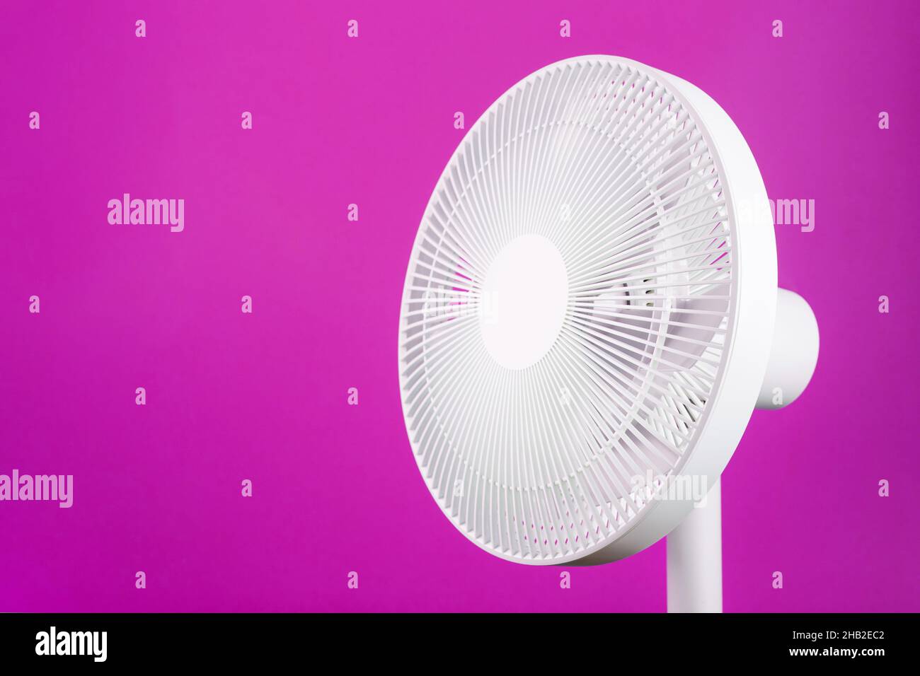 A high-tech white electric fan with a modern design for cooling the ...