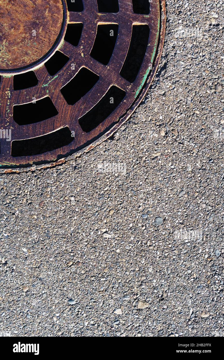 Sewer round hatch with a grate on an asphalt road. Top view Stock Photo ...