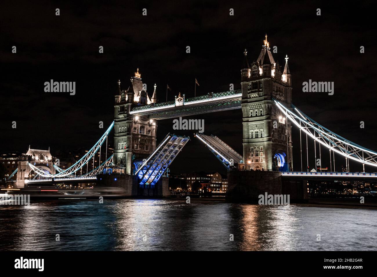 London Tower Bridge lifting up at night Stock Photo - Alamy