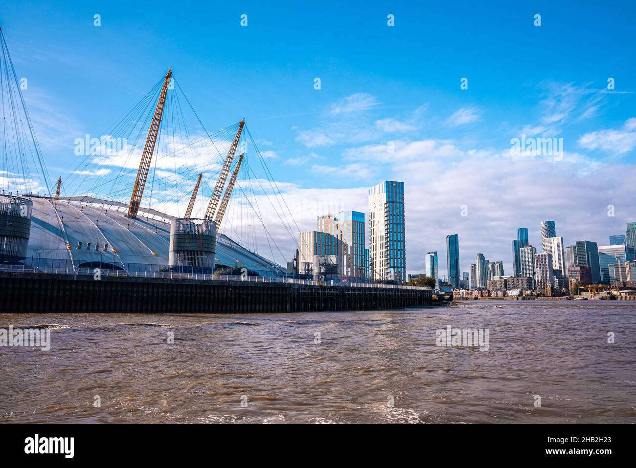 View from the river Thames over Millennium dome or O2 Arena in London ...