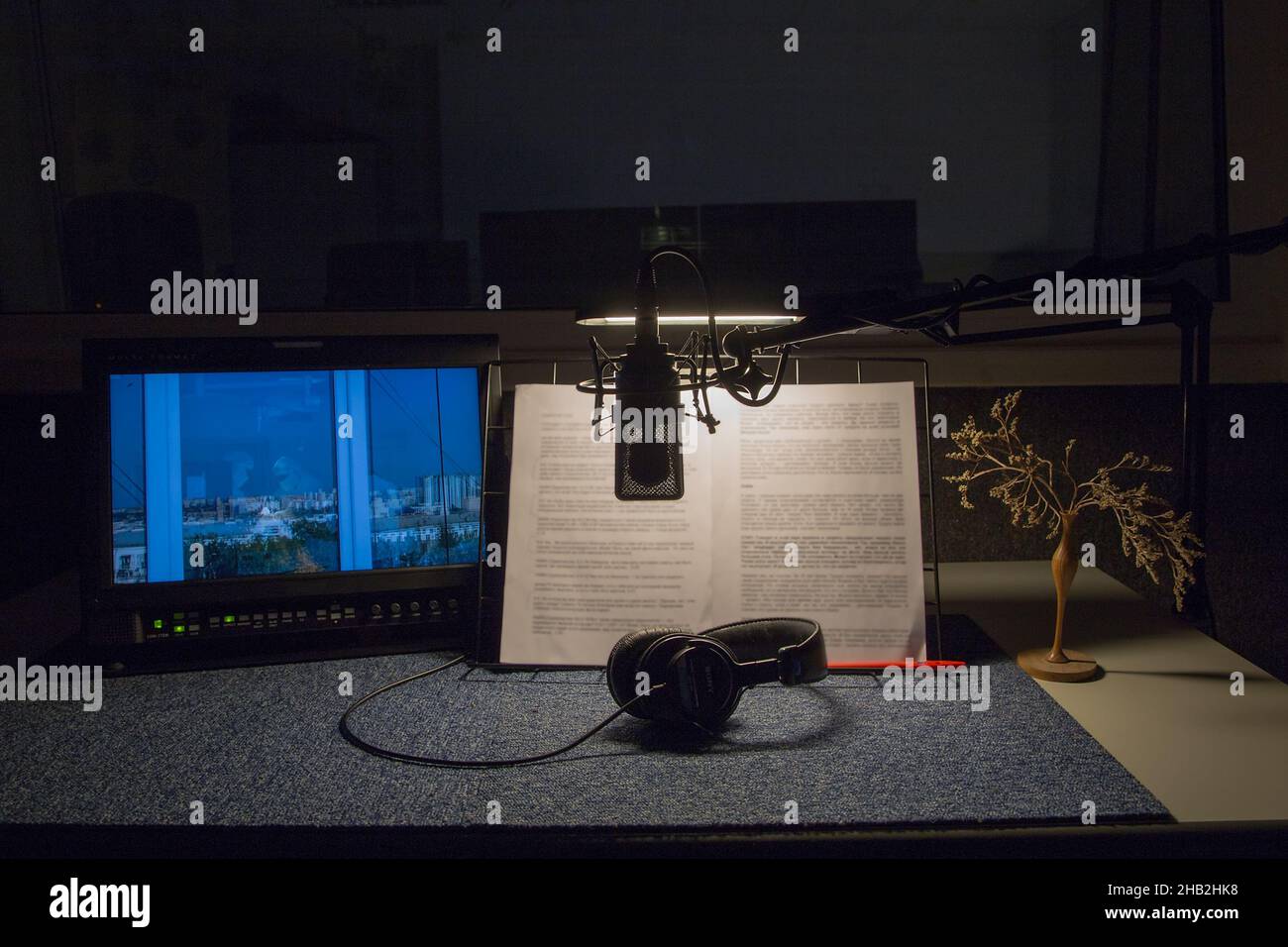 Professional condenser microphone with headphones in recording studio ...