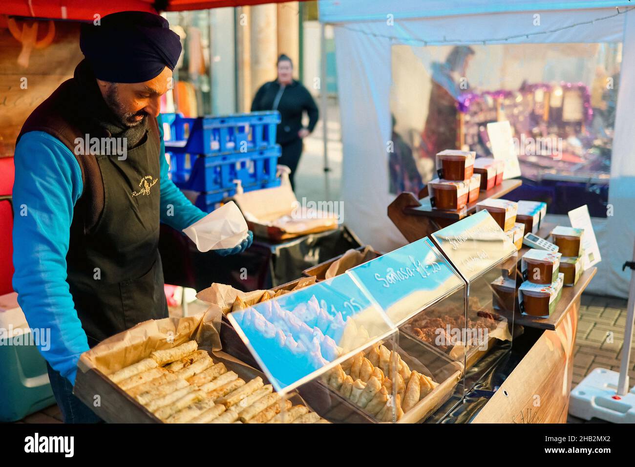 A Sikh man selling traditional food at a Christmas market Stock Photo ...