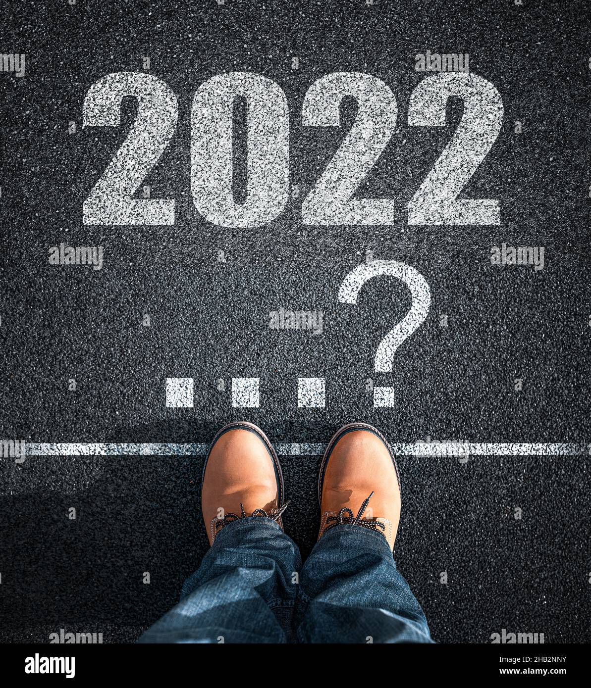 Feet of a man in yellow boots against the background of the inscription ...