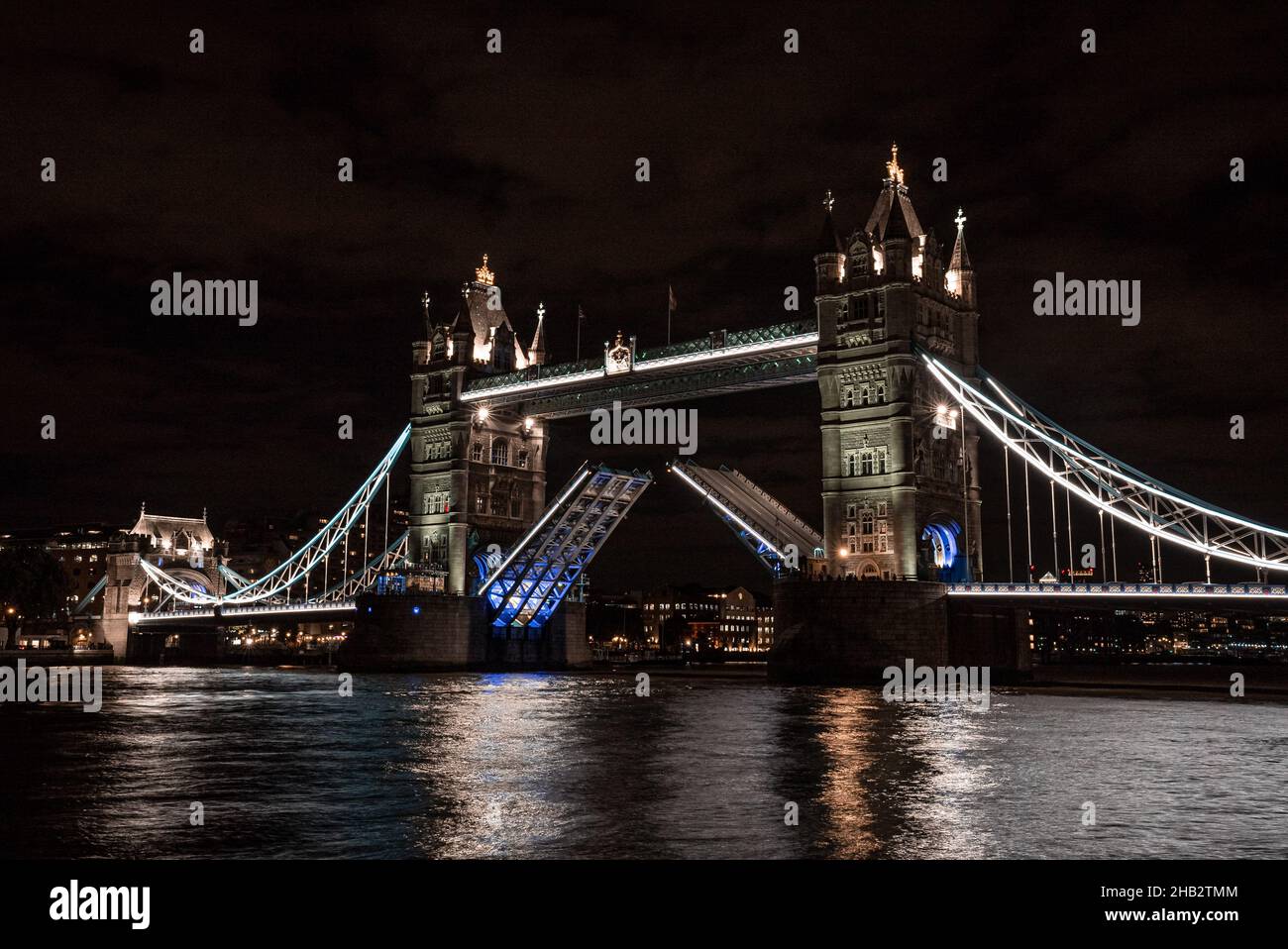 London Tower Bridge lifting up at night Stock Photo - Alamy