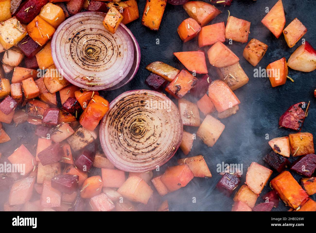 Close up of vegetables cooking over fire Stock Photo - Alamy