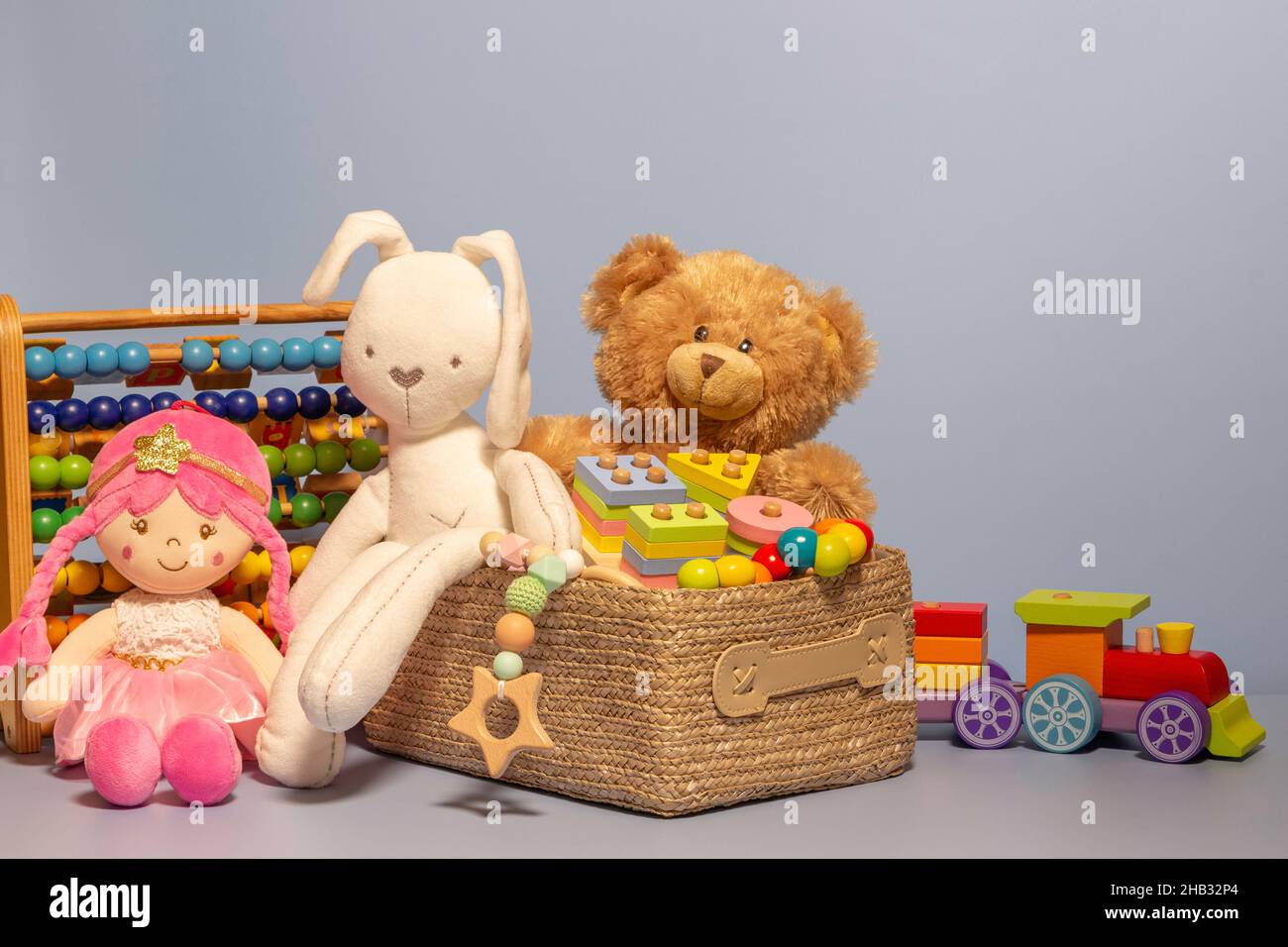 Toy box full of baby kid toys. Container with teddy bear, fluffy and ...