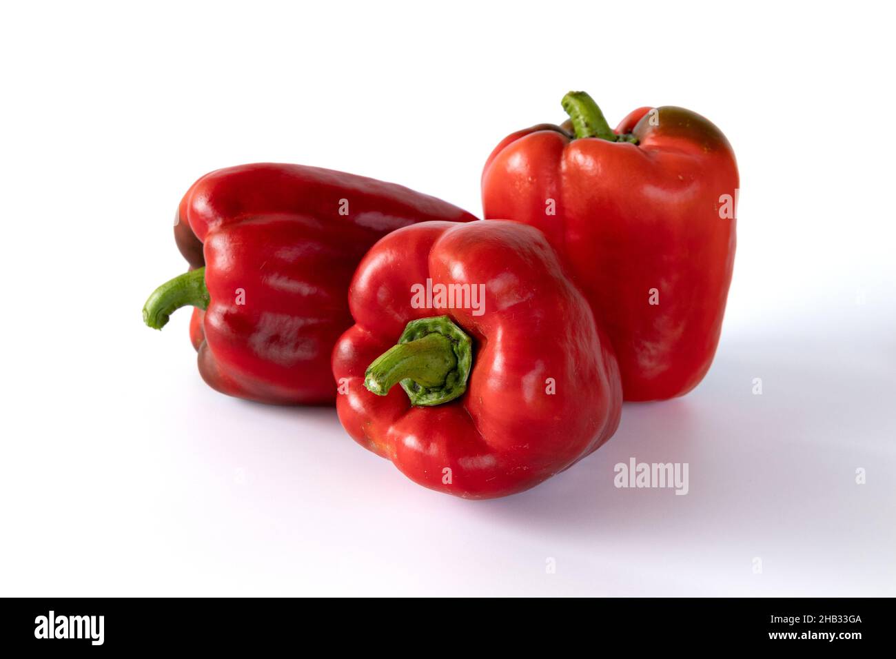three fresh ripe sweet peppers isolated on white background, raw ...