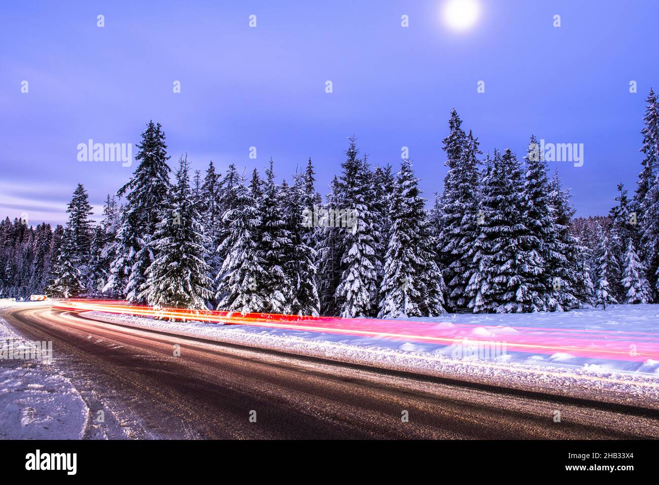 Car Light Trials in Winter Road in Mountains Stock Photo - Alamy