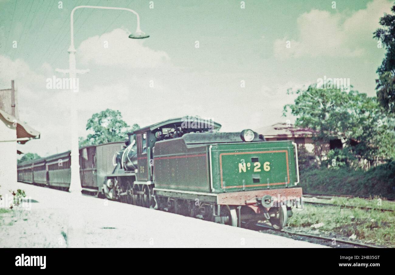 Steam train number 26 and passenger carriages at railway station ...