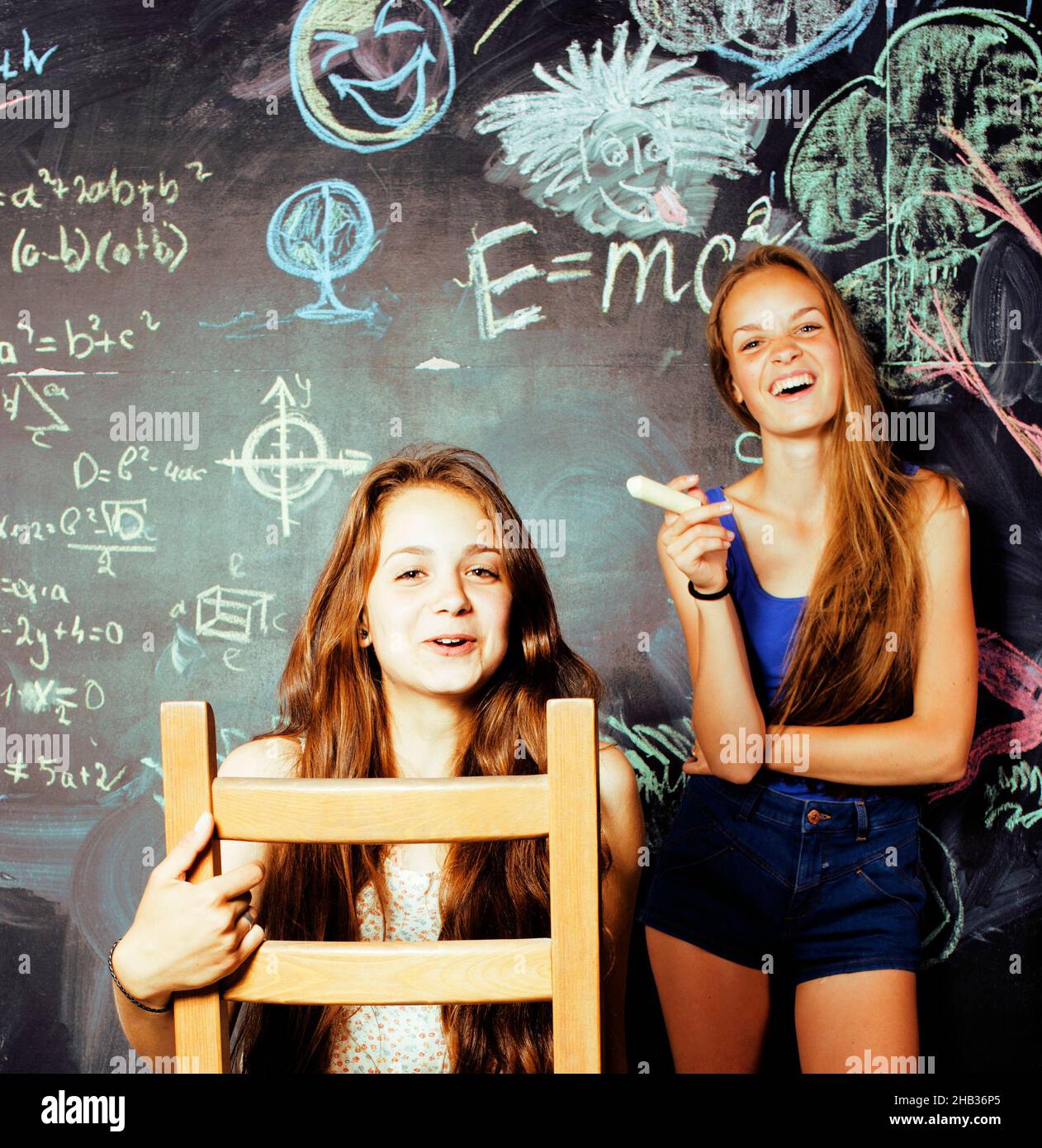 back to school after summer vacations, two teen girls in classroom with ...