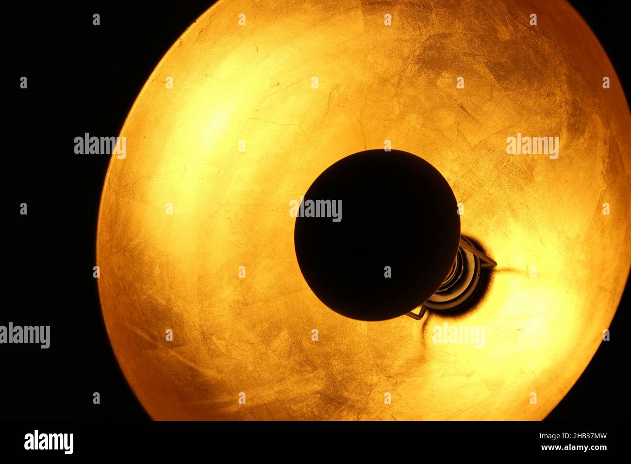 Warm golden lamp against a black background Stock Photo - Alamy