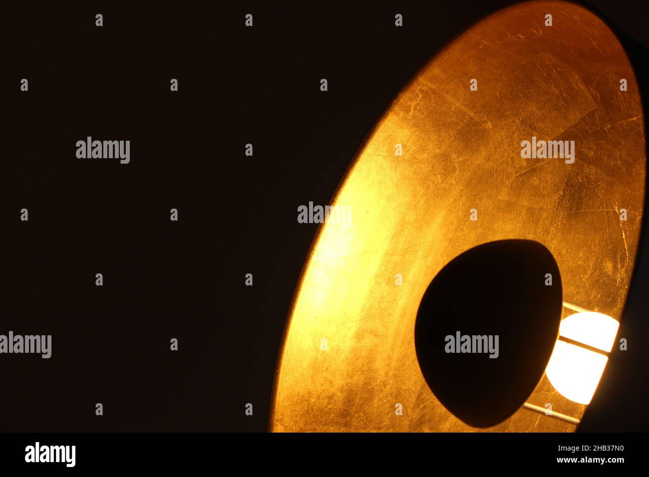 Warm golden lamp against a black background Stock Photo - Alamy