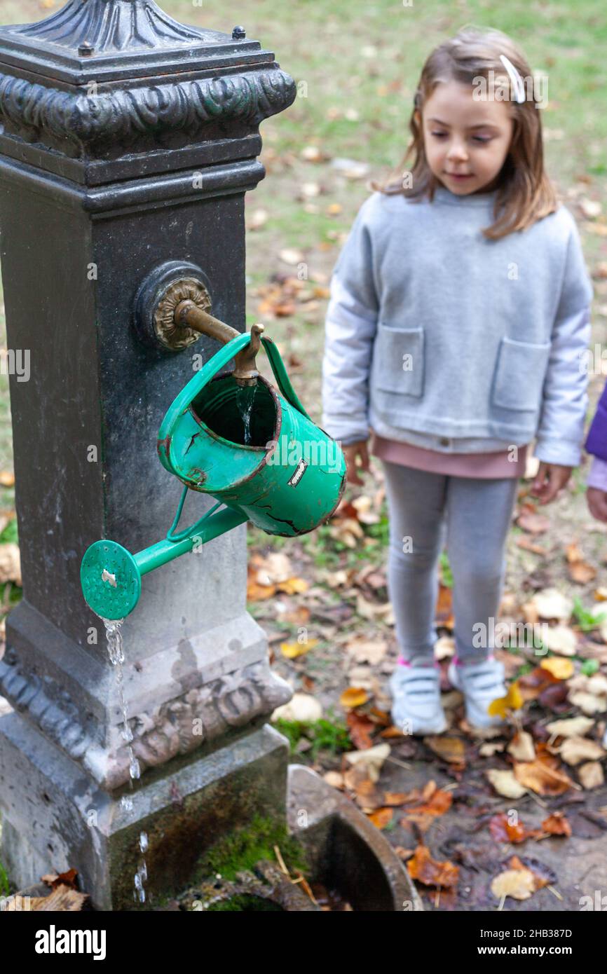Young Caucasian girl throwing out the trash in a park Stock Photo - Alamy