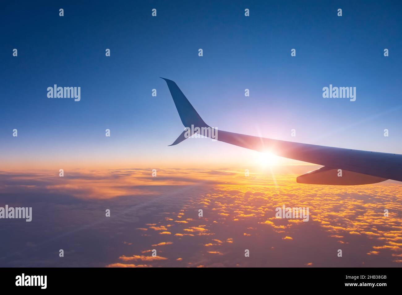 Sunset sky from an airplane wing view of the horizon and sun lights ...