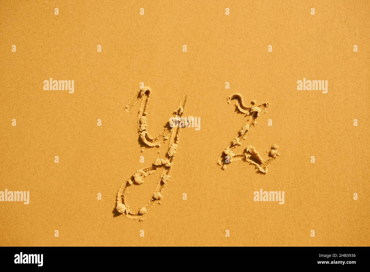 alphabet letters t z handwritten in sand on beach Stock Photo - Alamy