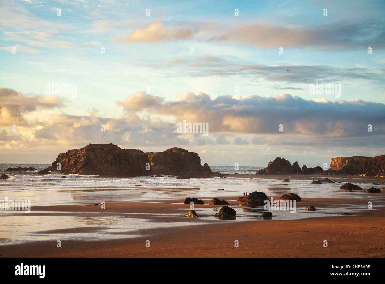 Bandon Beach Oregon sea stacks with colorful sunset sky and clouds ...