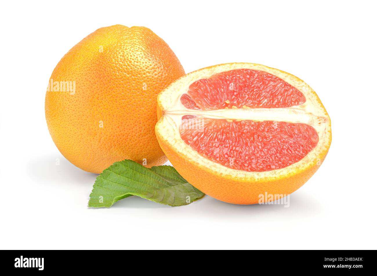 Ripe grapefruit with half and green leaf isolated on white background ...